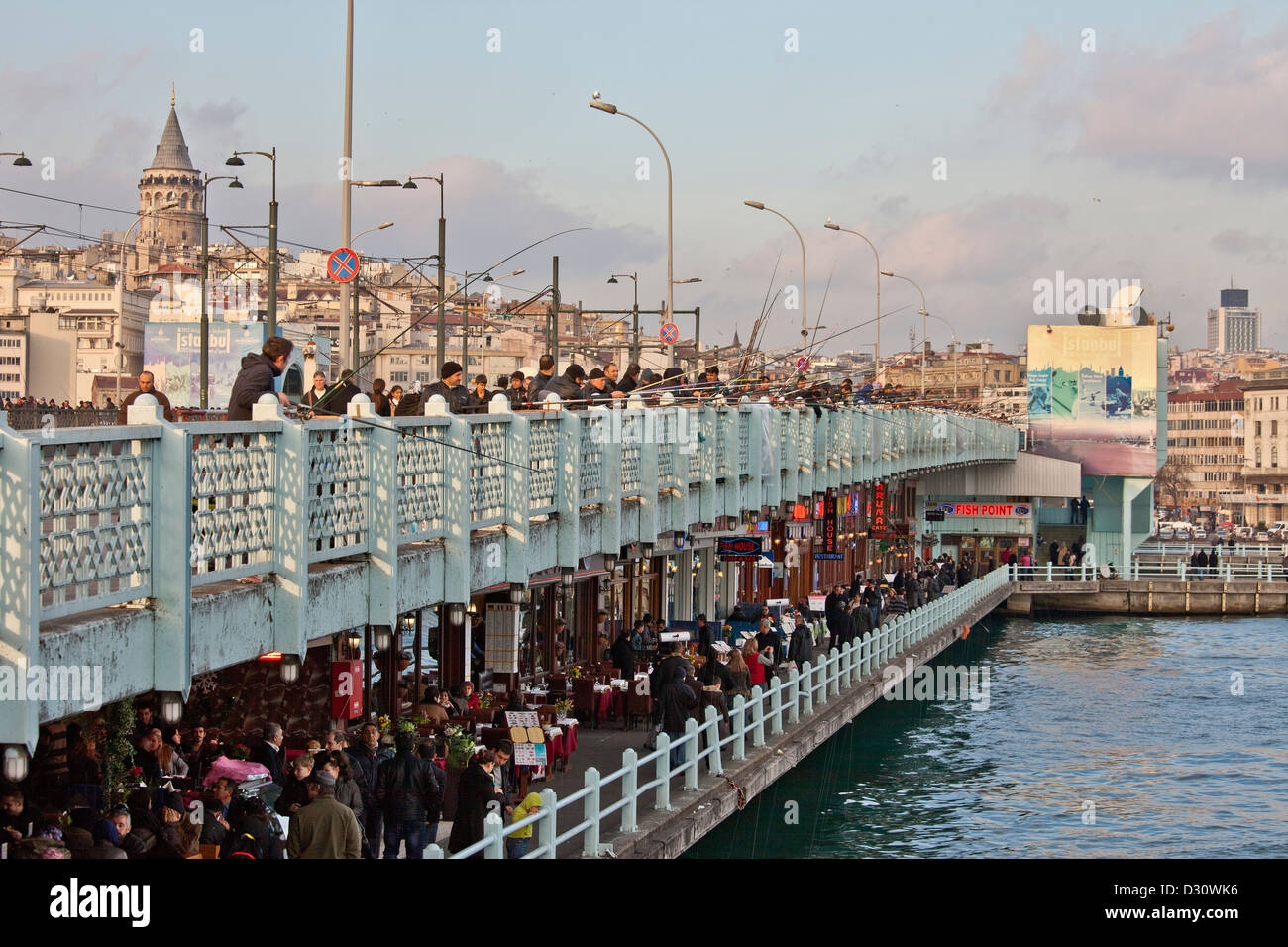ISTANBUL TURKEY - Fishermen and fishing rods on the Galata Bridge with ...