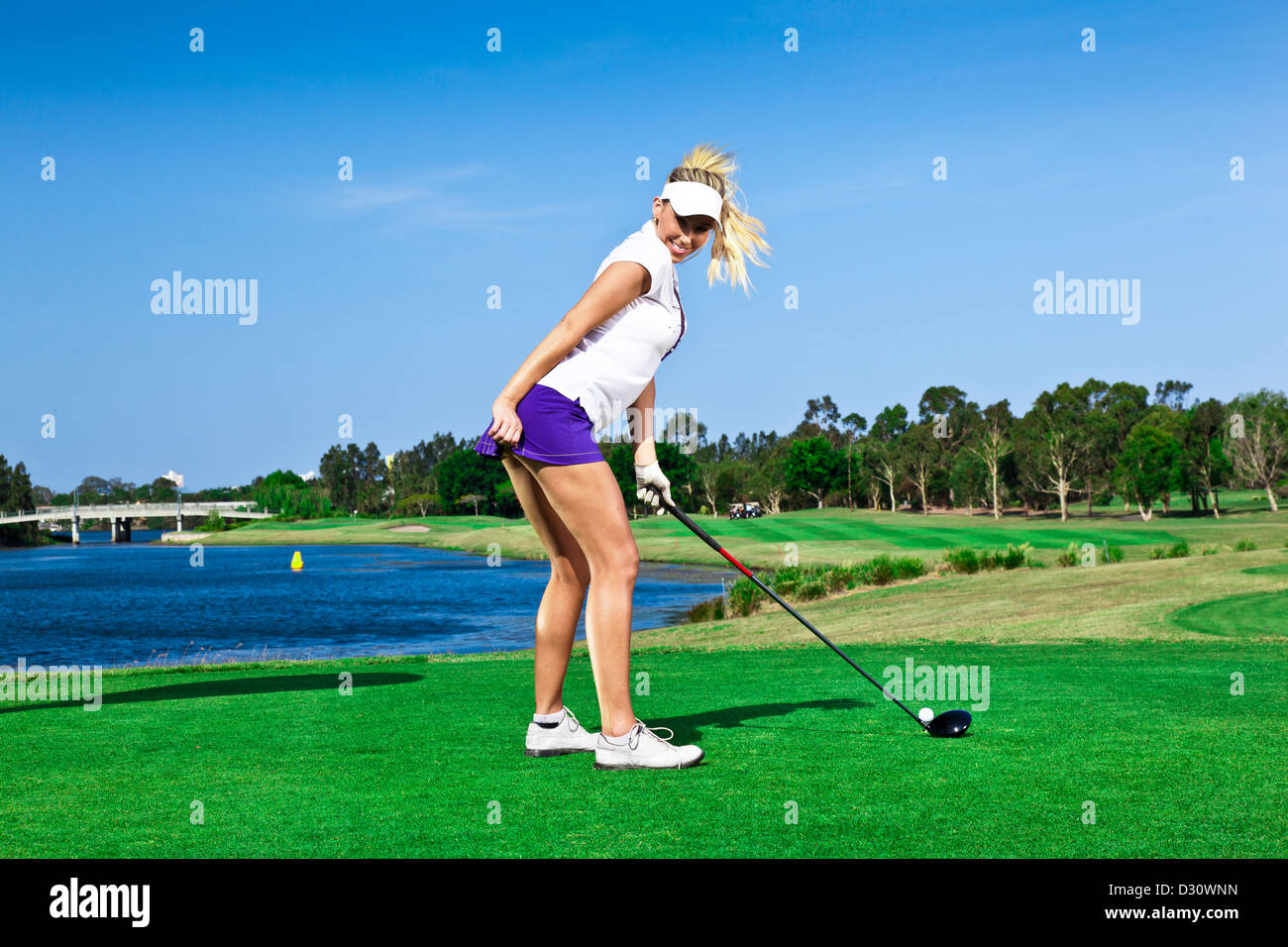 Attractive golfer girl on golf course with driver Stock Photo - Alamy