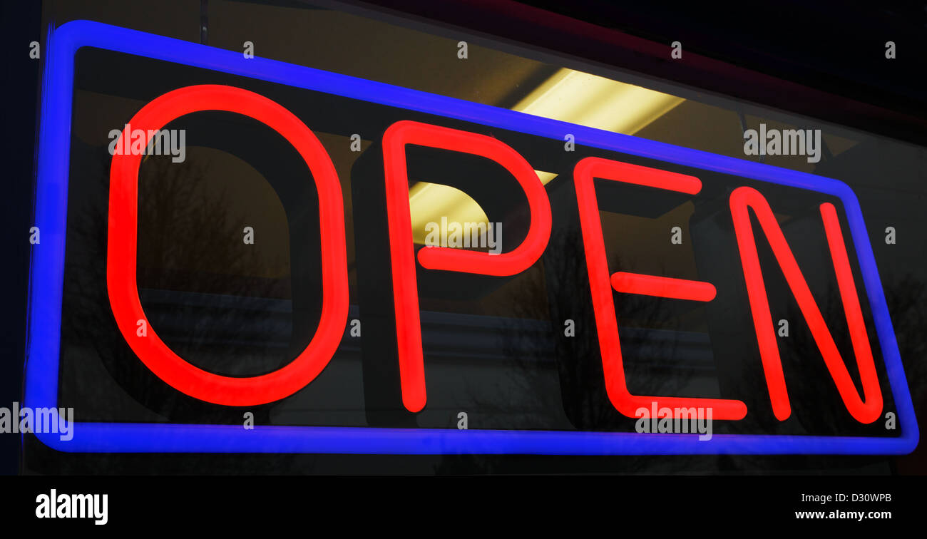 Red and blue neon open sign at store with background interior lights ...