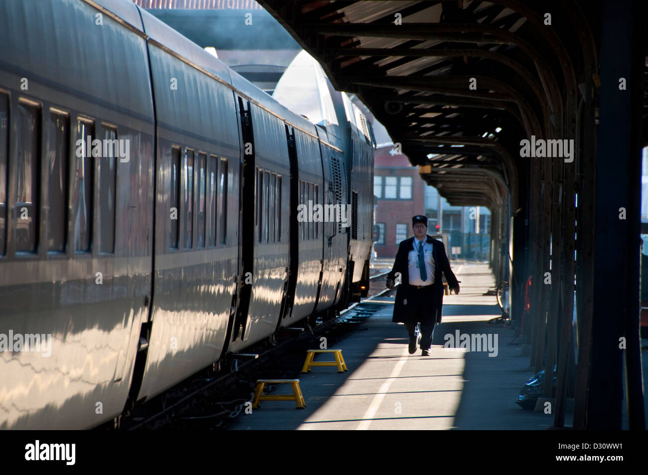 Amtrak train and conductor on the platform at Union Station in Portland ...