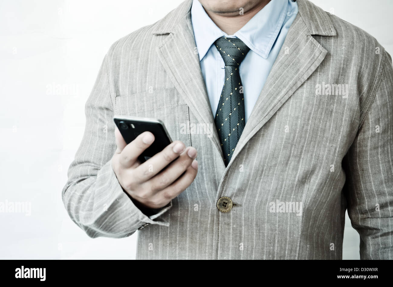 Business man working with phone on white background Stock Photo - Alamy