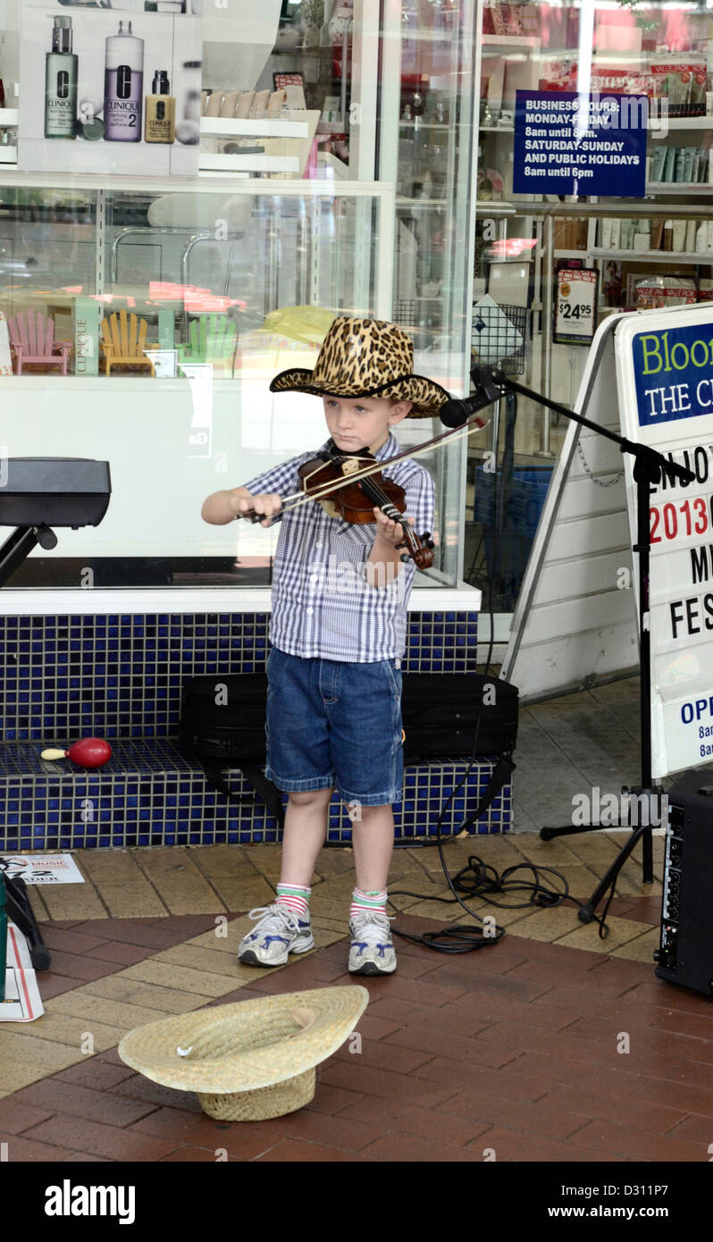 Young boy in crazy hat busking at Tamworth Country Music Festival ...
