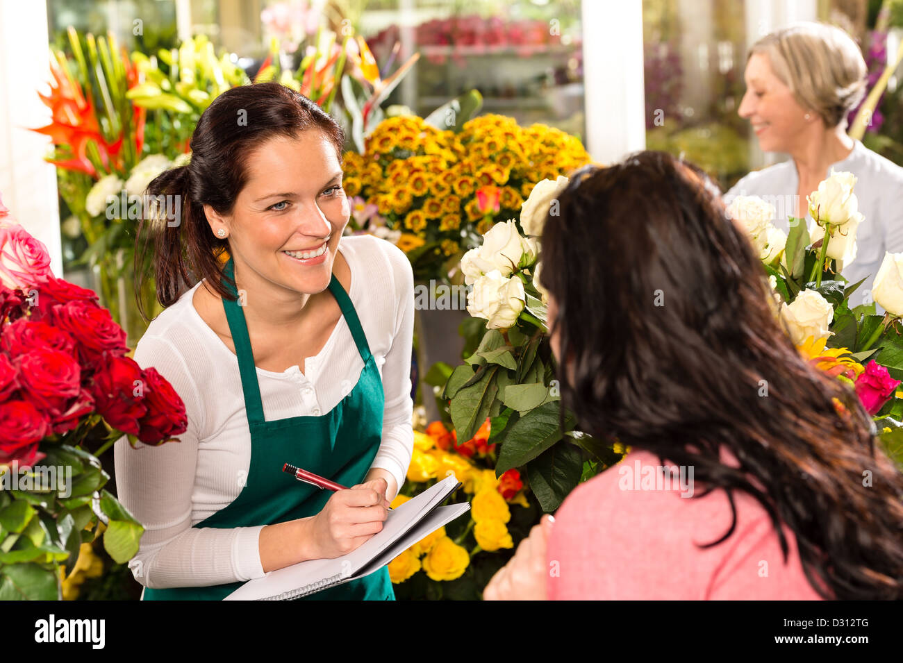 Happy flower store assistant hi-res stock photography and images - Alamy