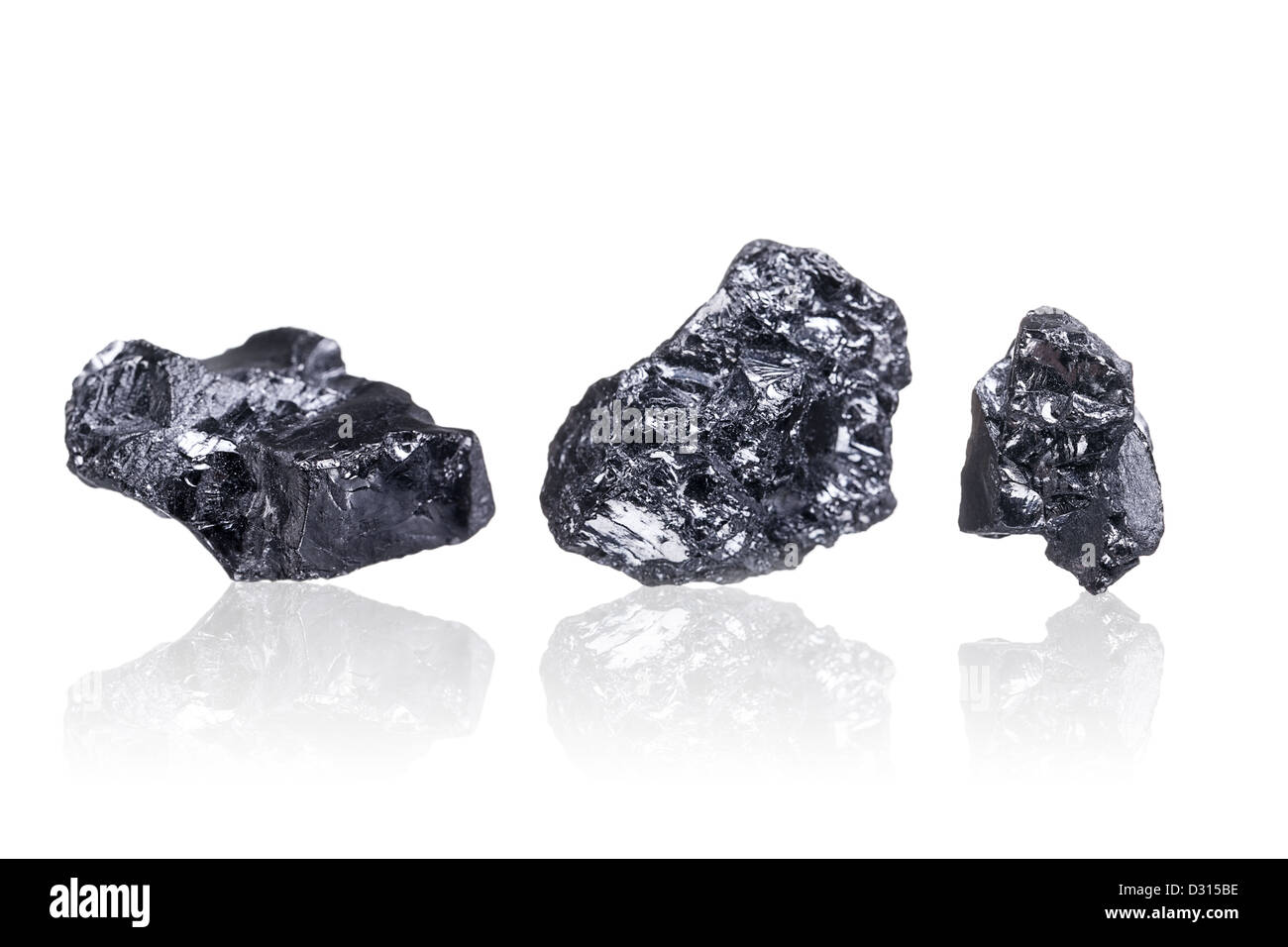 three pieces of a small Anthracite coal, isolated on white with a ...