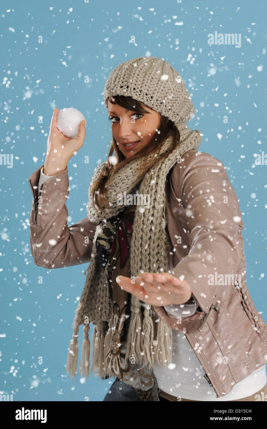 snowing on a woman throwing a snow ball Stock Photo - Alamy