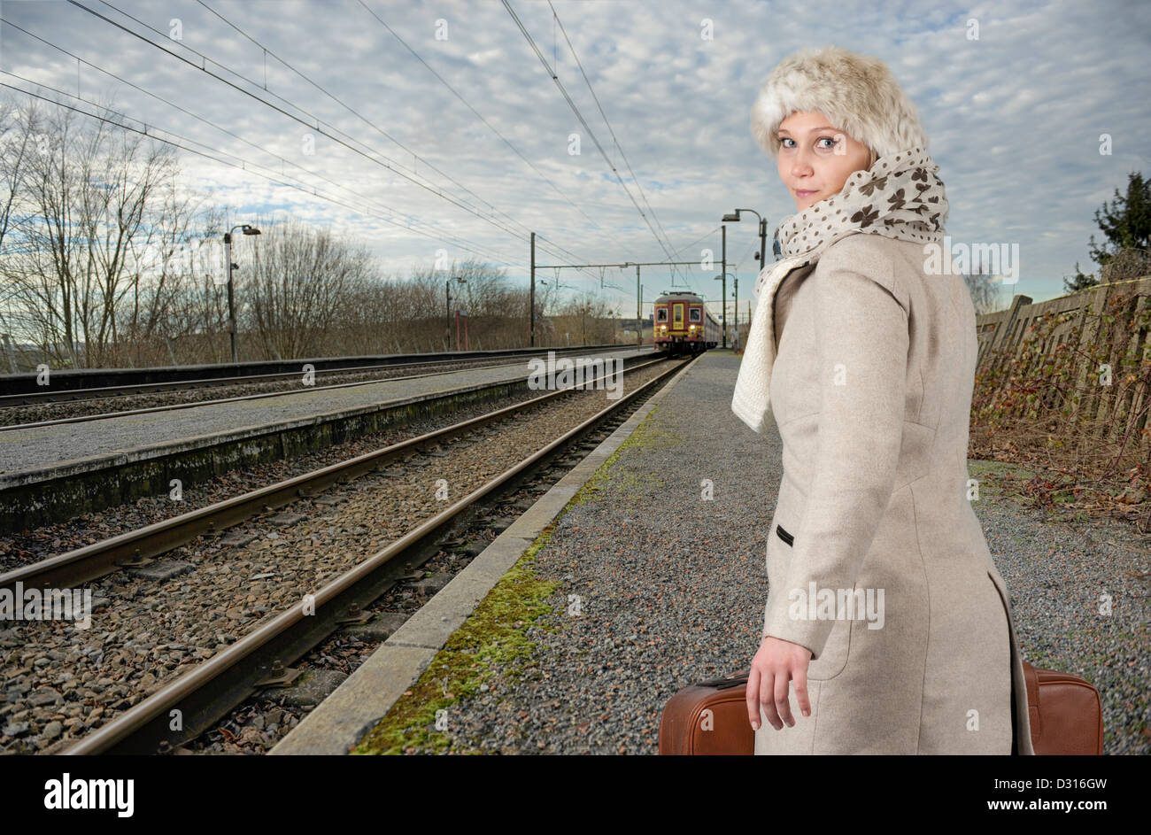young woman waiting for her train Stock Photo - Alamy