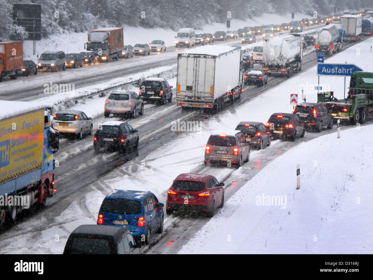 Cars stuck in traffic on the snow-covered motorway near Alpen, Germany ...