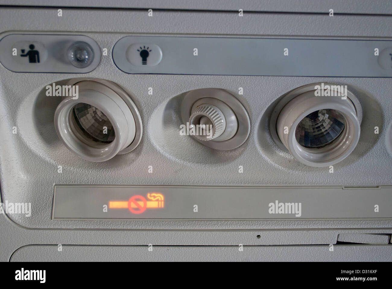 Cabin inside the aircraft, lights, air condition and signs panel above ...