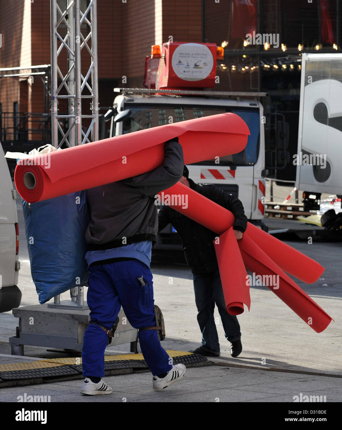Workers carry the red carpet for the upcoming Berlin International Film ...