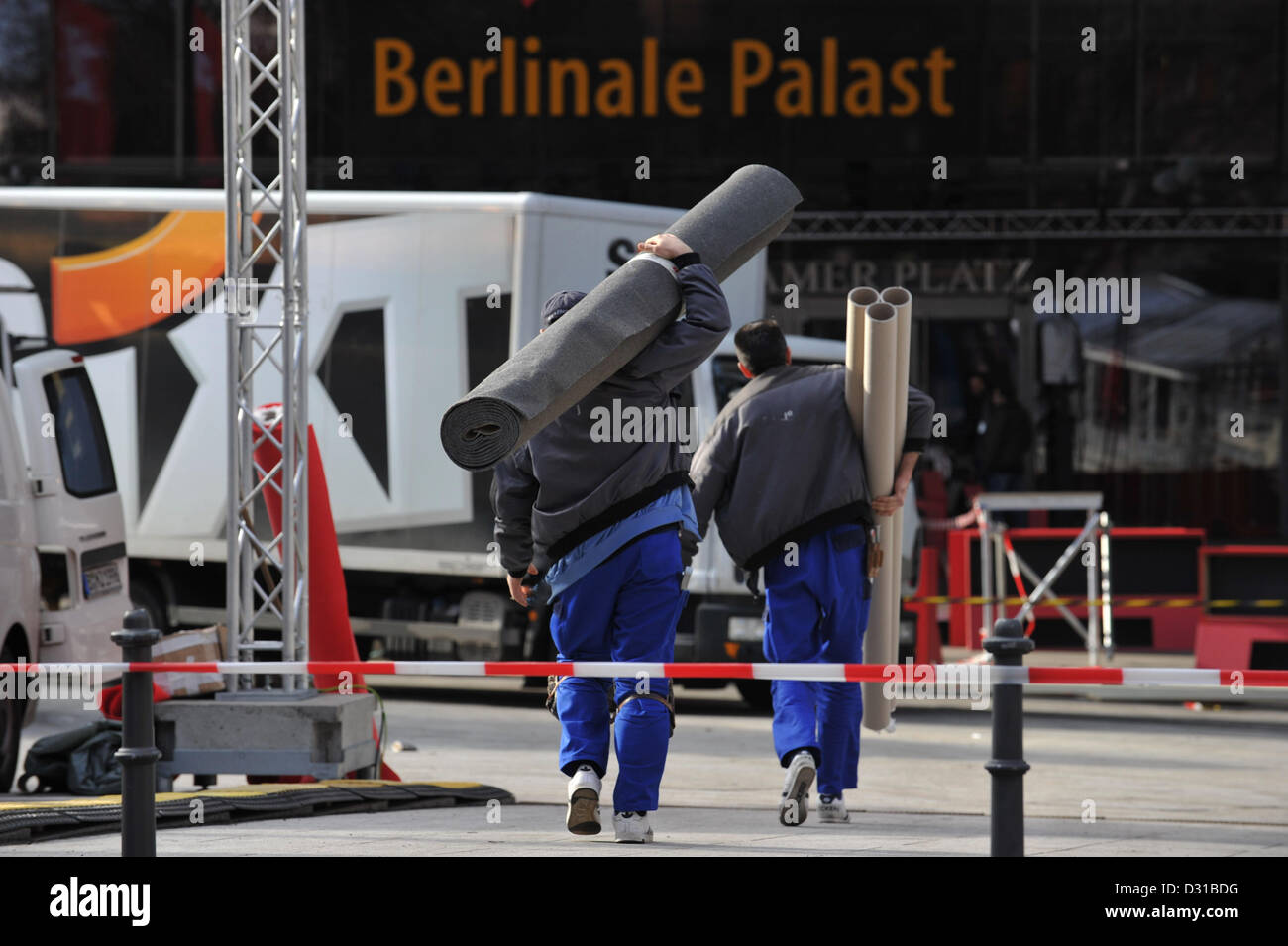Workers carry the red carpet for the upcoming Berlin International Film ...