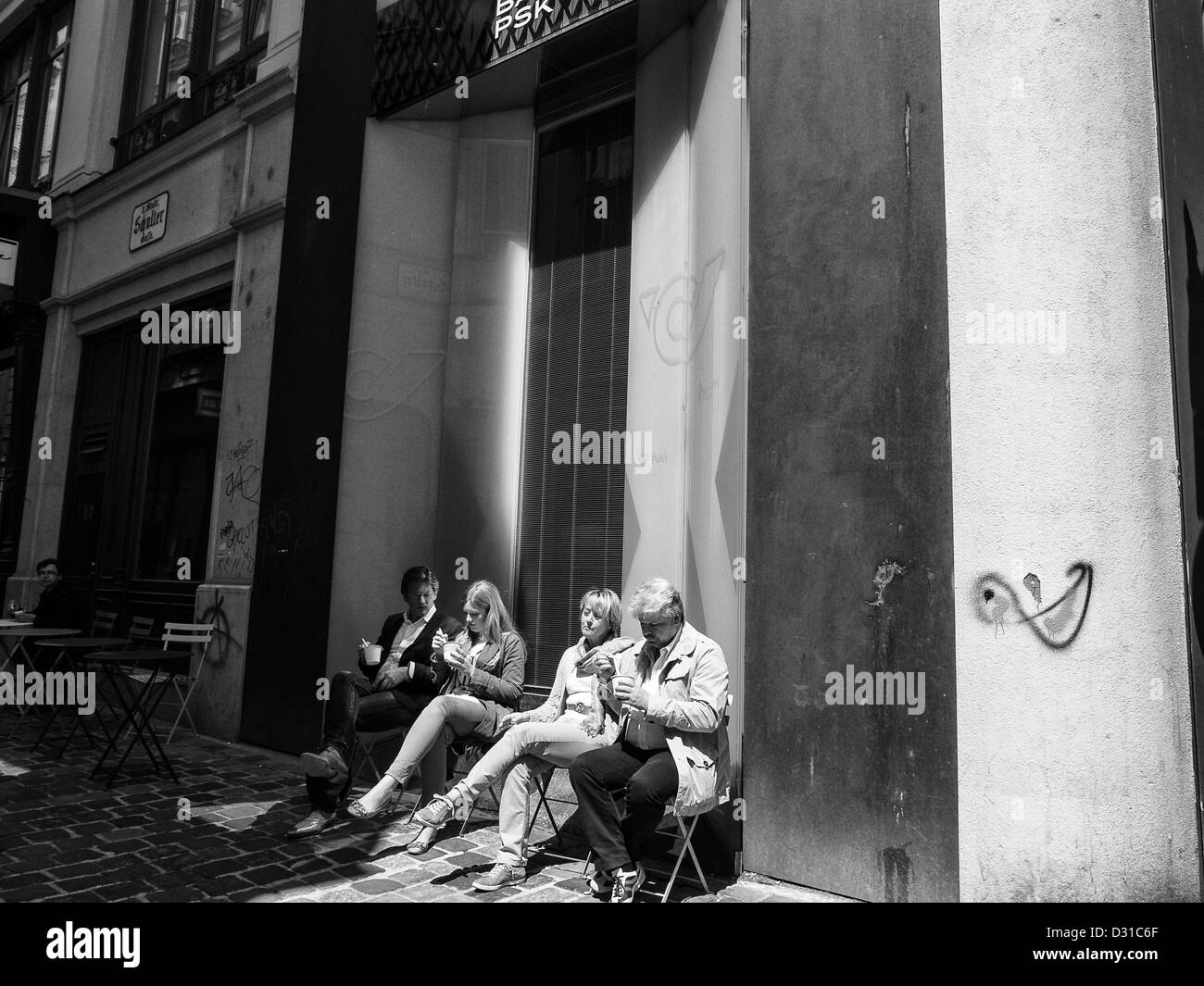 people sitting on a small coffee with chairs in sunlight Stock Photo ...
