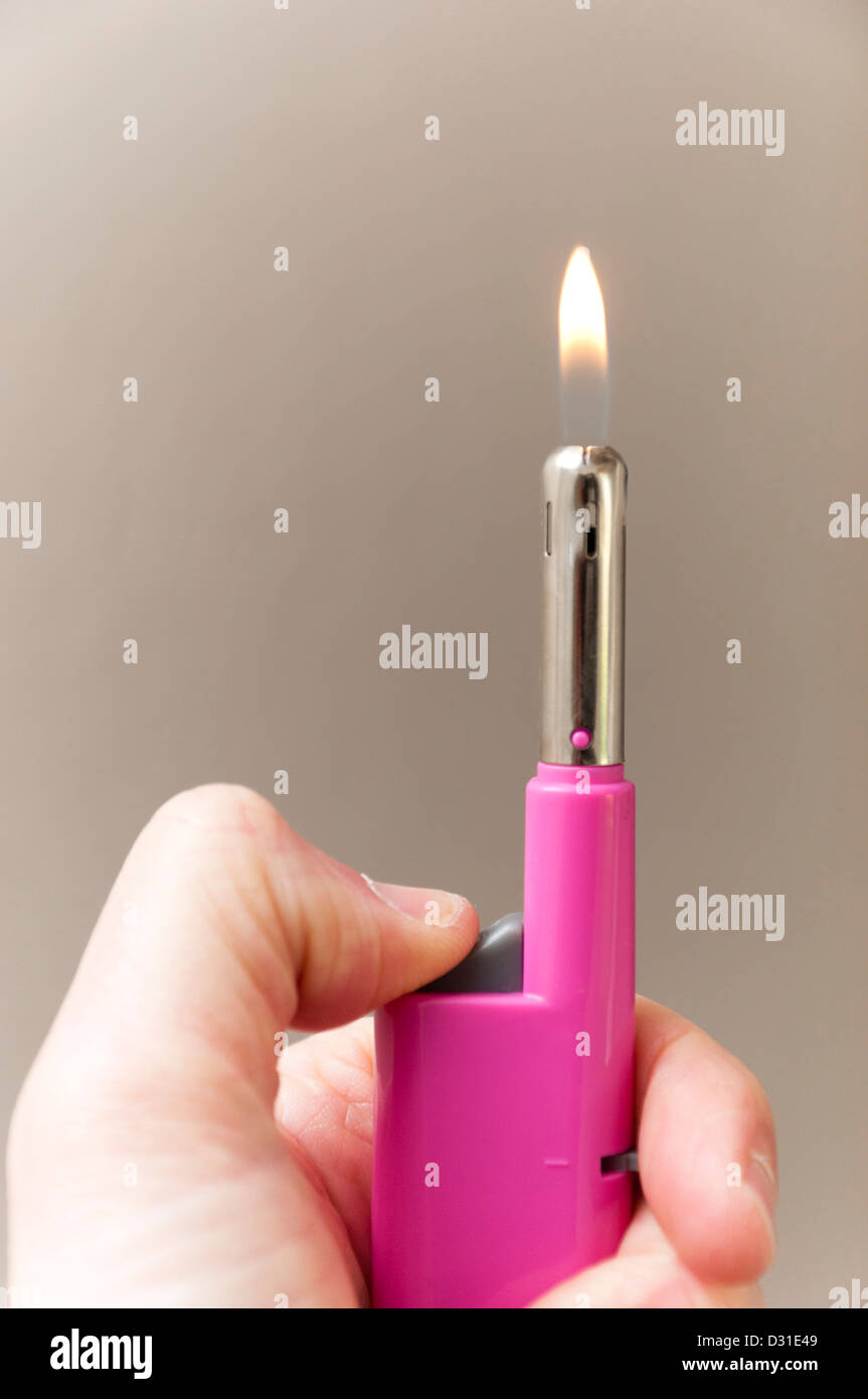 Small gas lighter with flame Stock Photo - Alamy