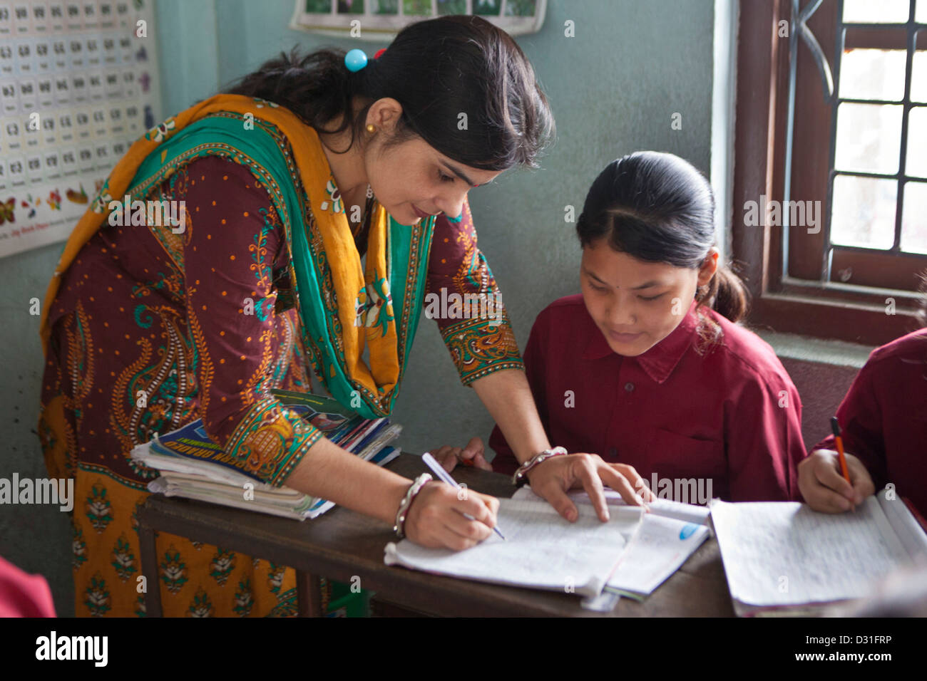 Nepalese school children and teacher during a lesson in a classroom at ...
