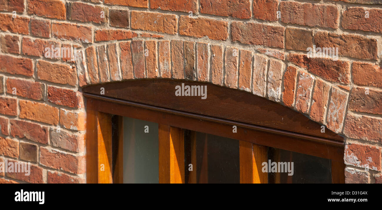 Arched brickwork over a window on a newly renovated barn in rural ...