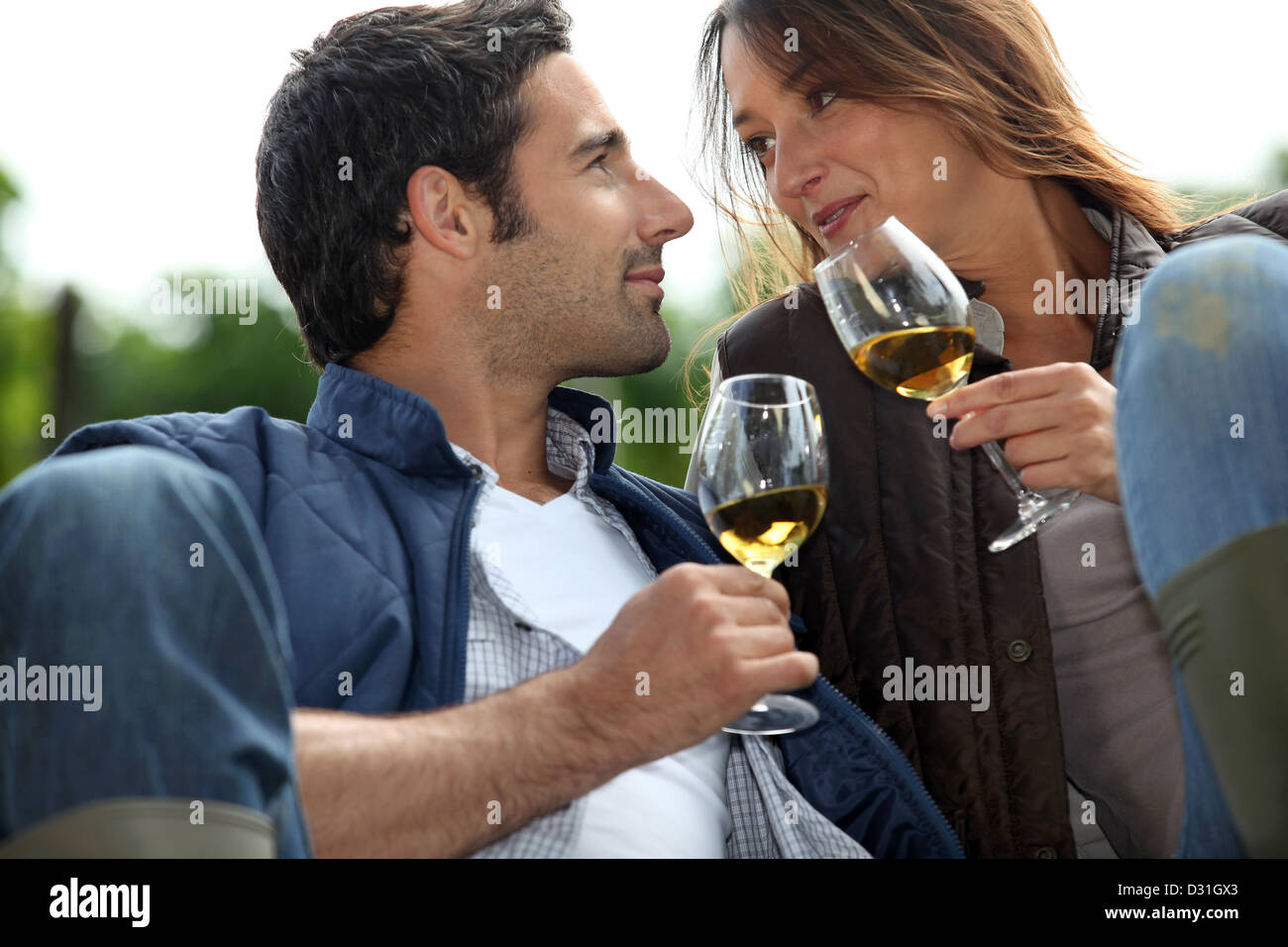 Couple drinking wine in a vineyard Stock Photo - Alamy