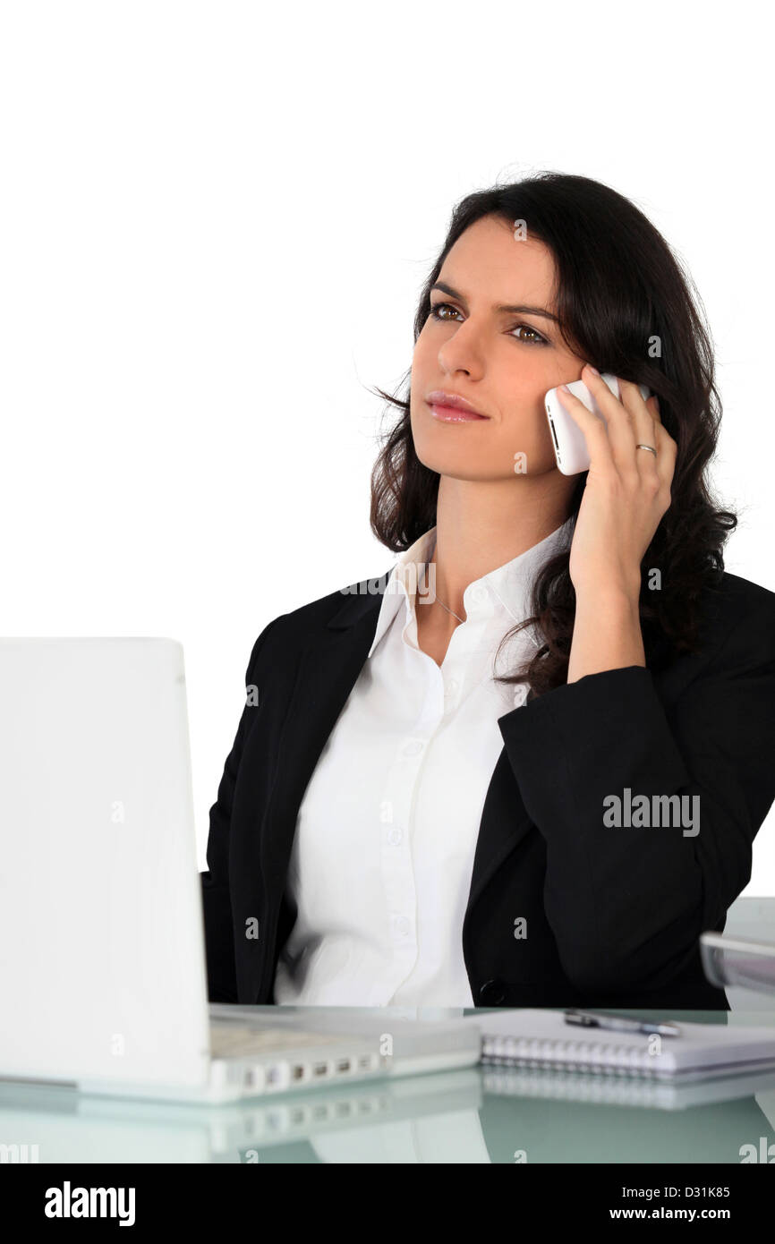 Secretary concentrated on the phone Stock Photo - Alamy
