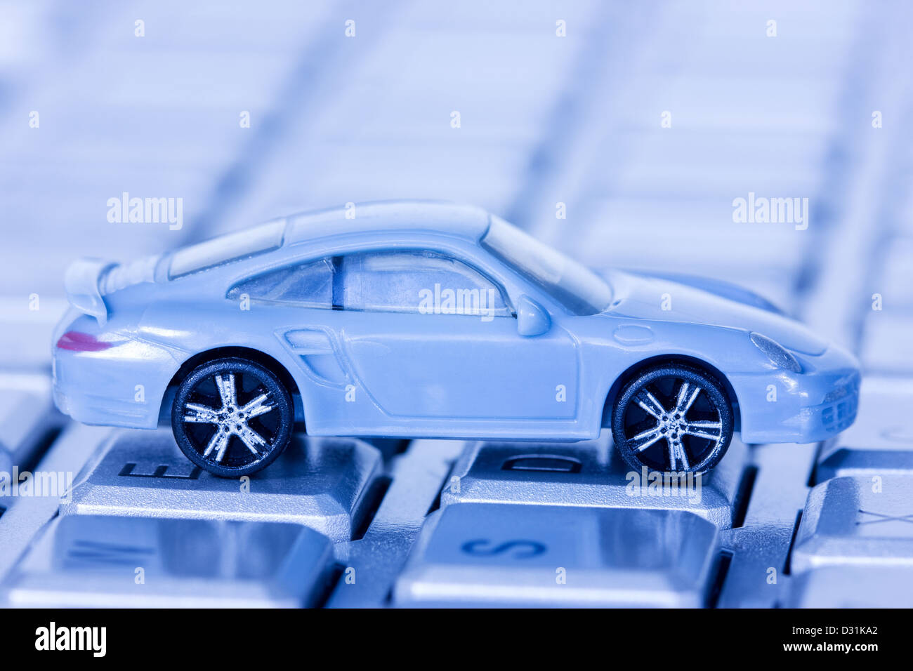 Picture of small car on the computer keyboard Stock Photo - Alamy