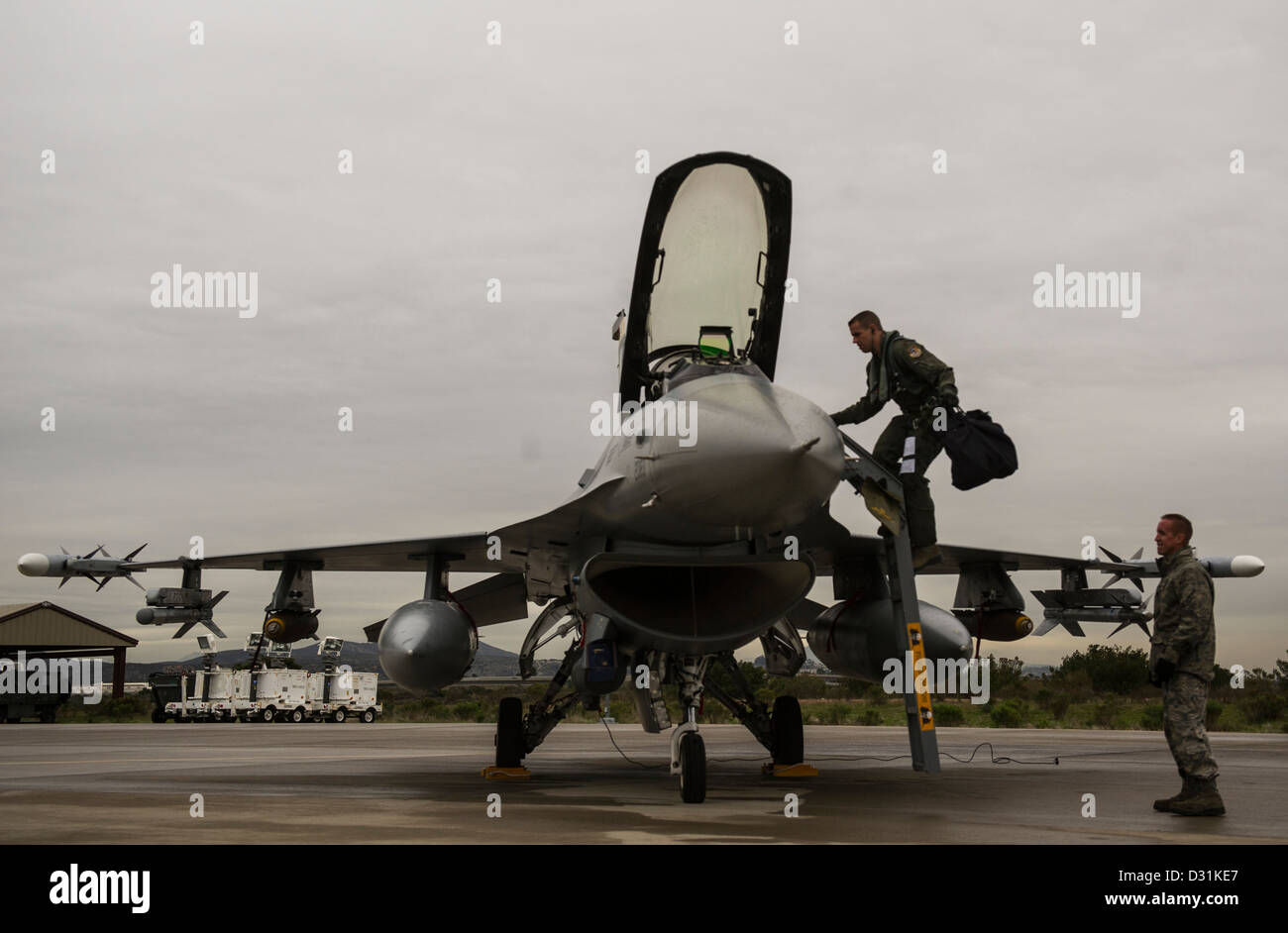 Pilot gets into cockpit of his U.S. Air Force F-16 Fighting Falcon ...