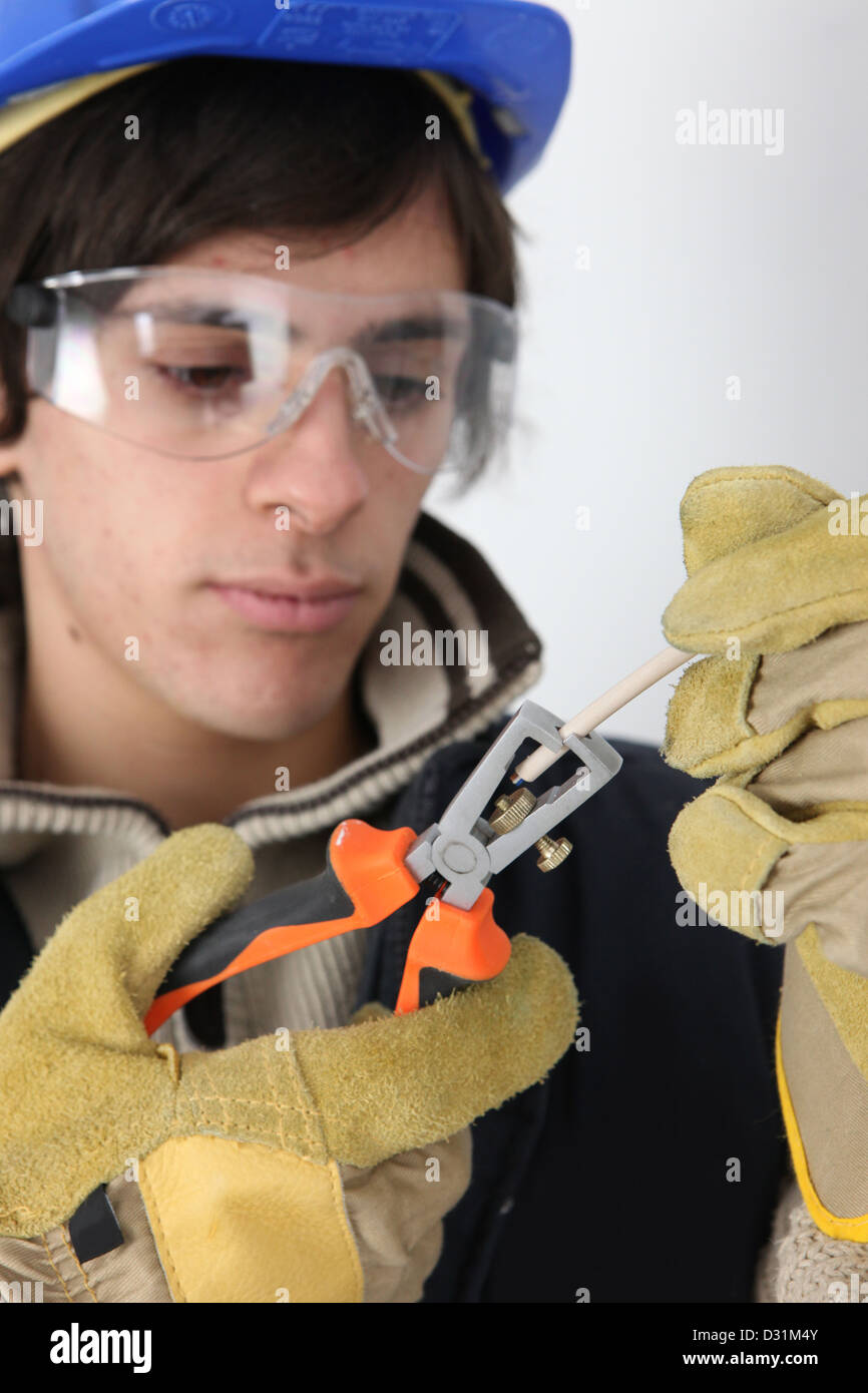 craftsman cutting a cable Stock Photo - Alamy