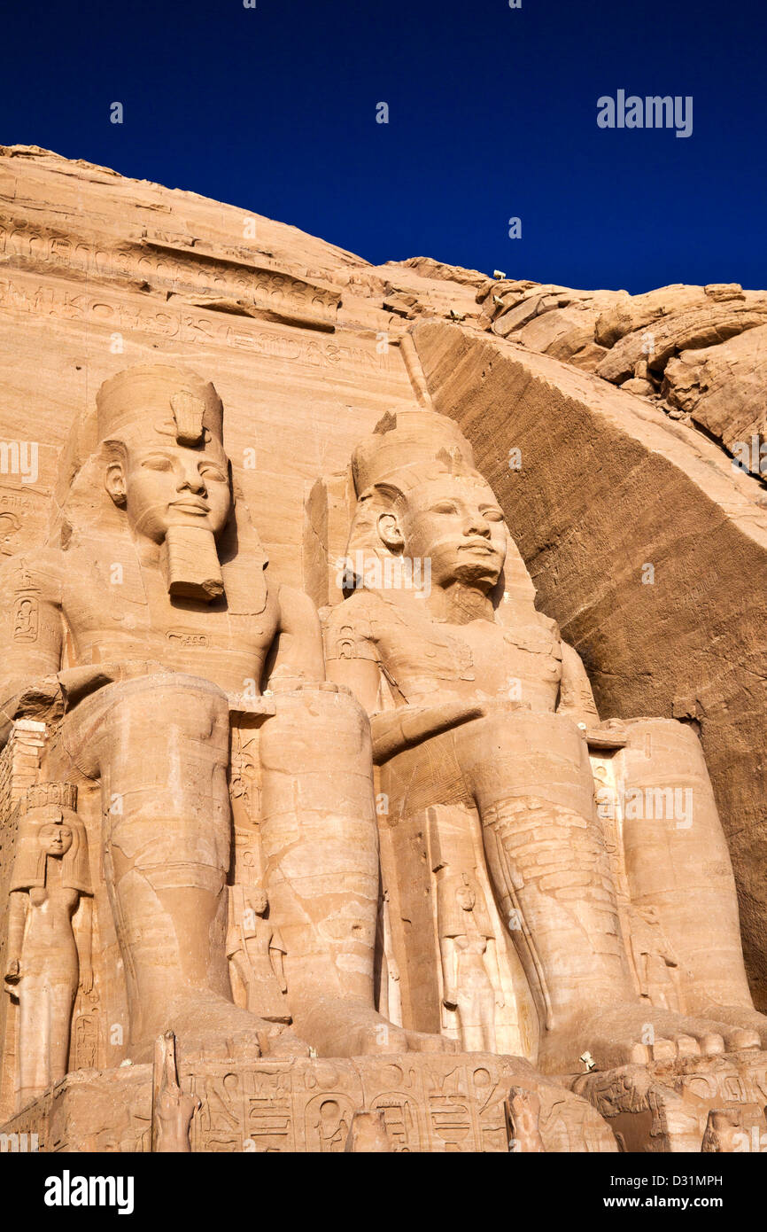 Statues of pharaoh Ramesses II wearing the double Atef crown of Upper ...
