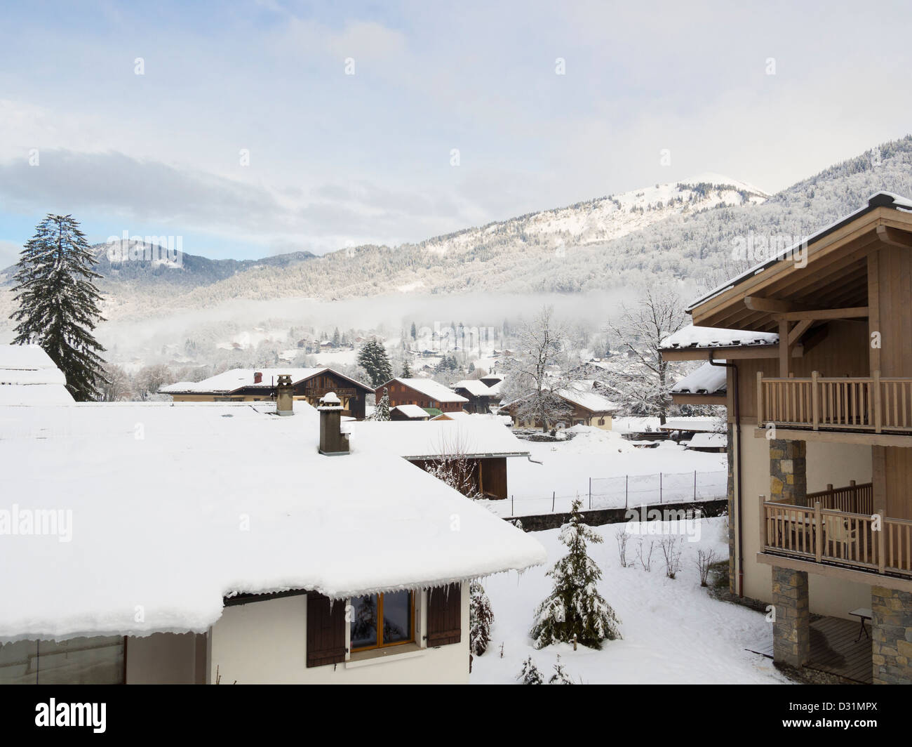 Alpine ski chalets and houses with snow in Samoëns village in Giffre ...