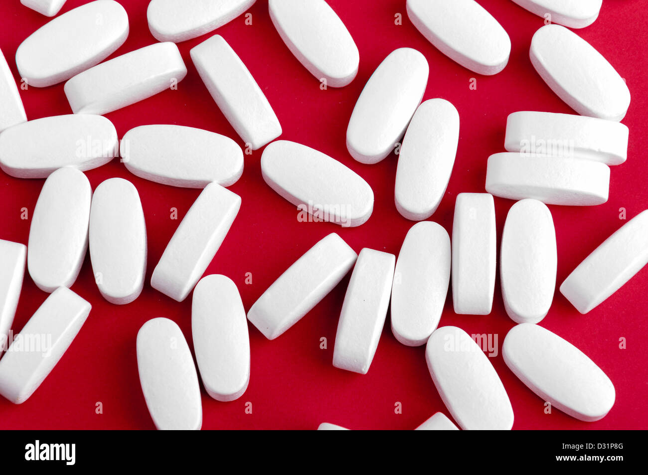 Drug in tablets on red background Stock Photo - Alamy