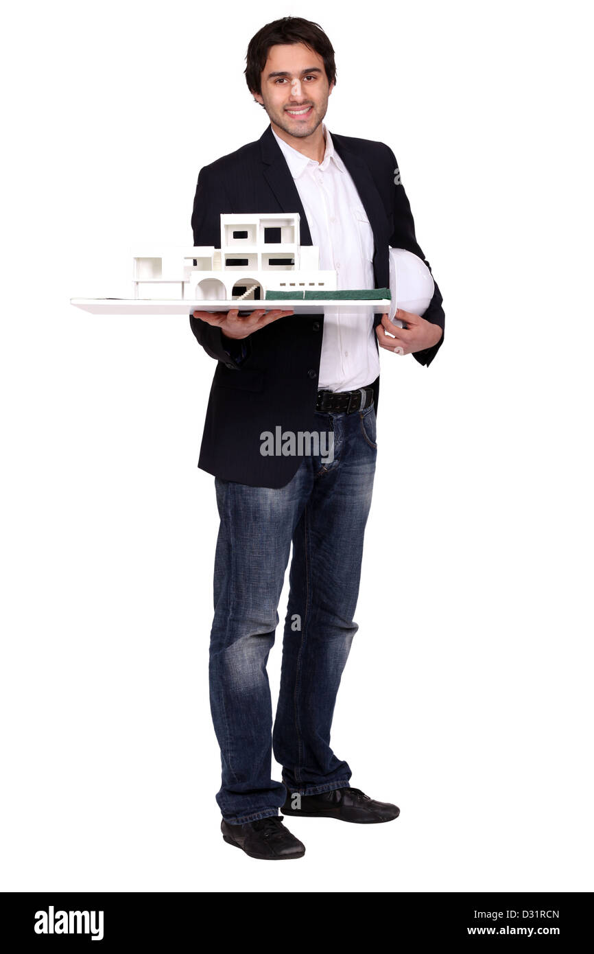 architect holding a helmet and a model of a house Stock Photo - Alamy