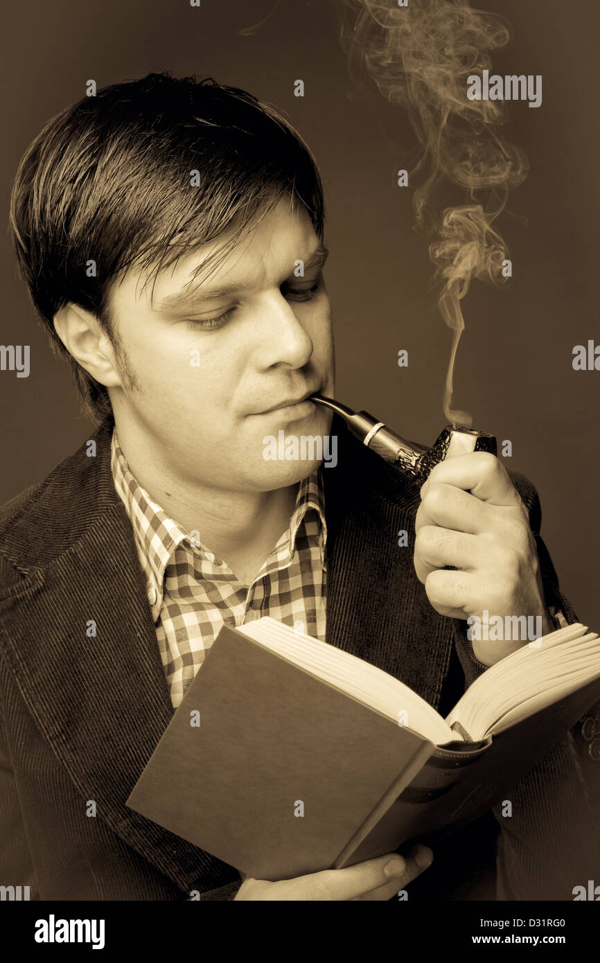 Portrait of a man reading and smoking a pipe. Close-up Stock Photo - Alamy