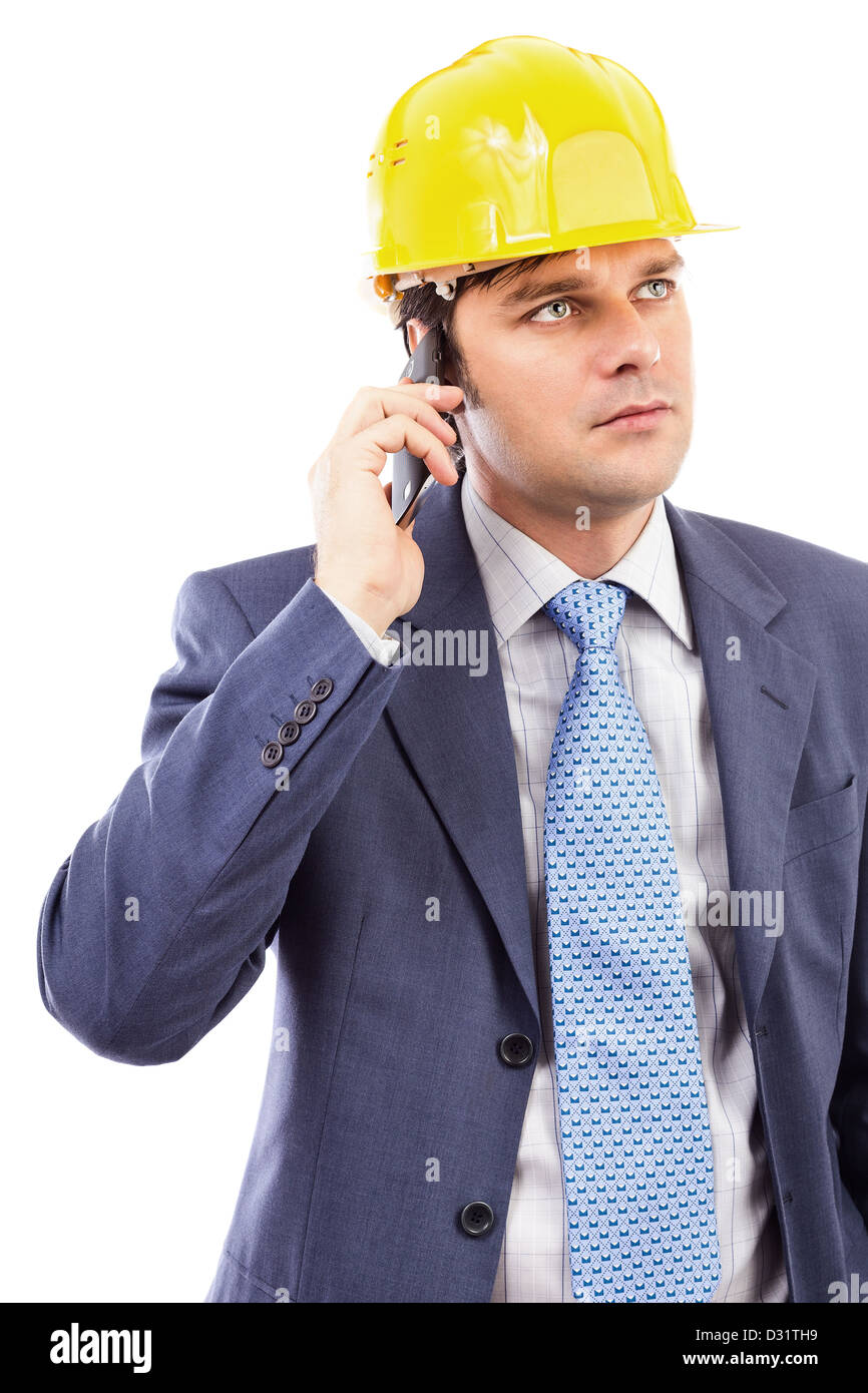 Portrait of a young engineer talking on the phone against white ...