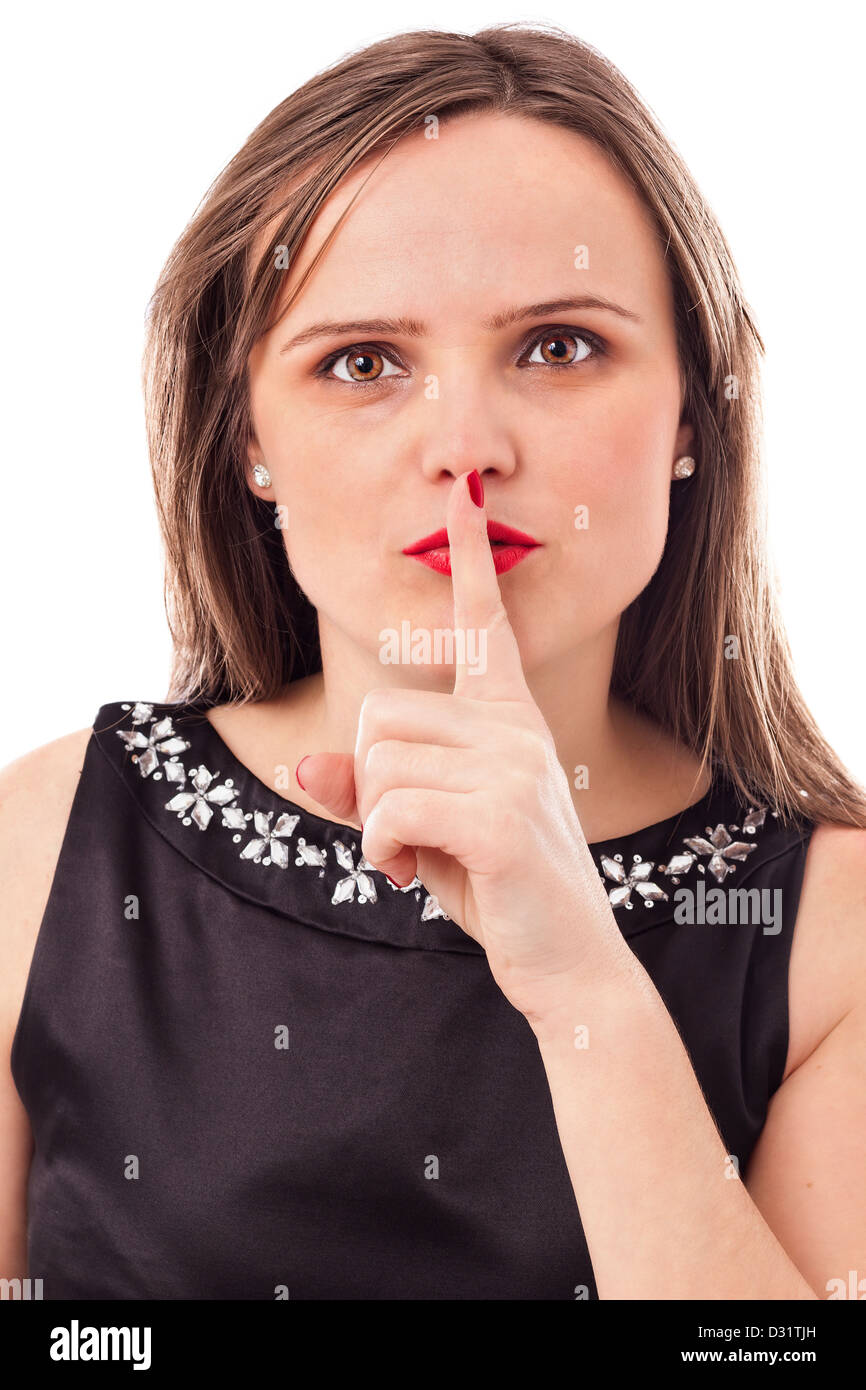 Pretty young woman making a keep it quiet gesture against white ...
