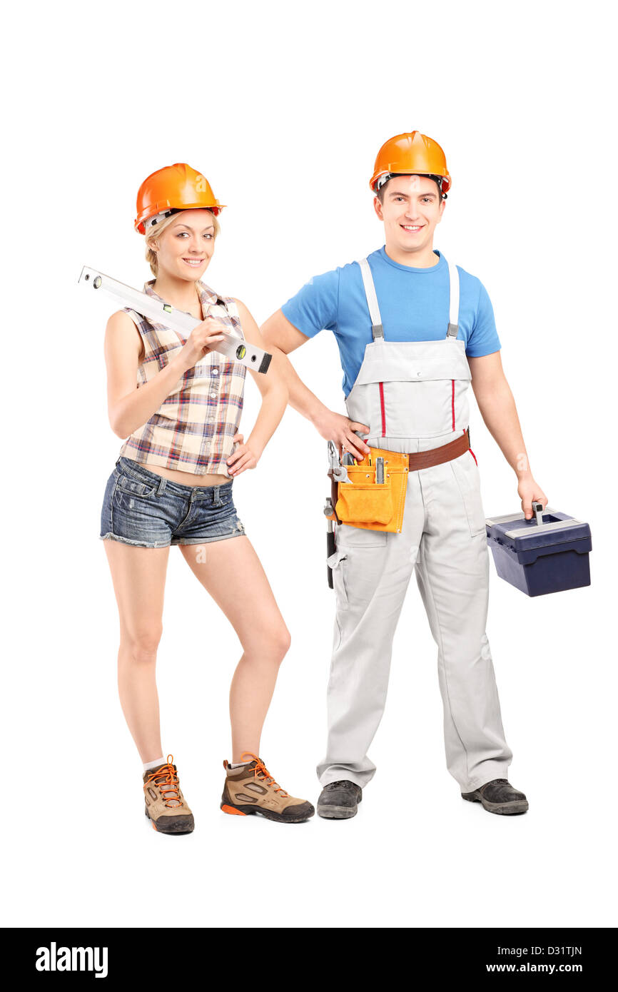 Team of a male and female construction workers holding tools isolated on white background Stock ...