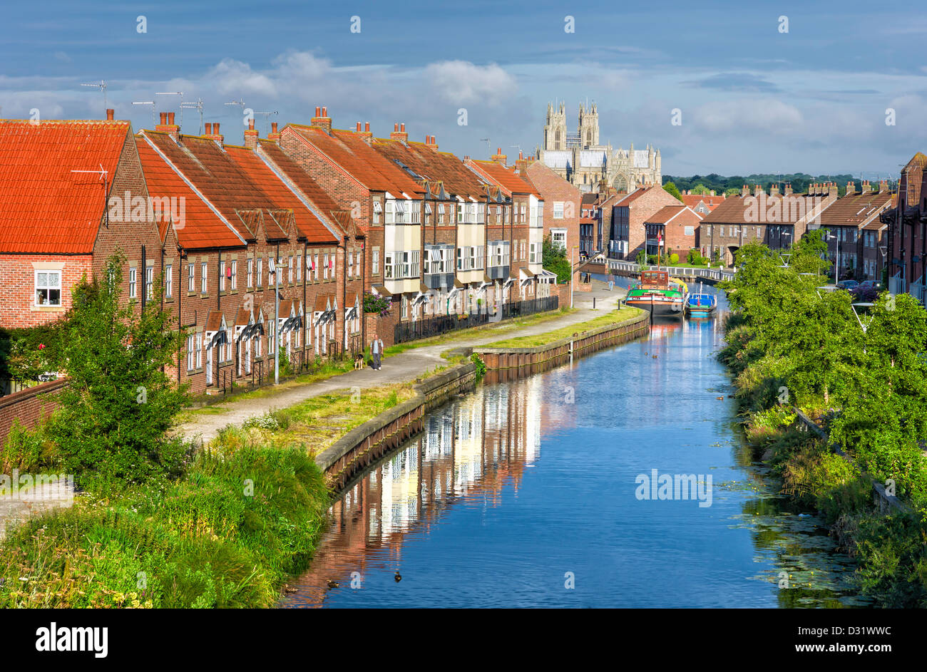 View of the beck, terrace houses, barges, and the Minster on a bright ...