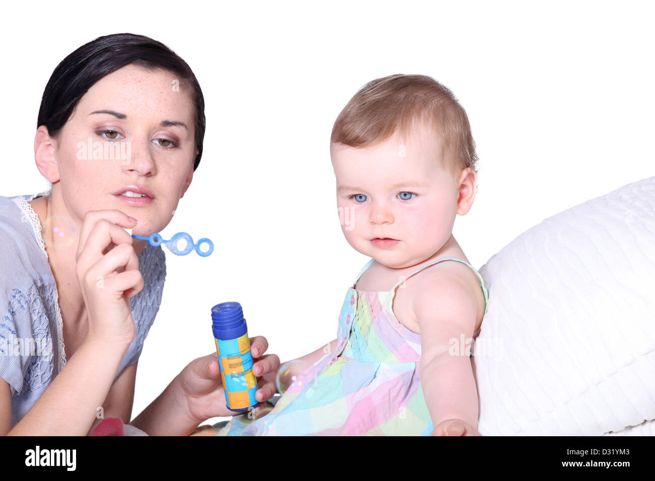 Mother with baby blowing bubbles Stock Photo - Alamy