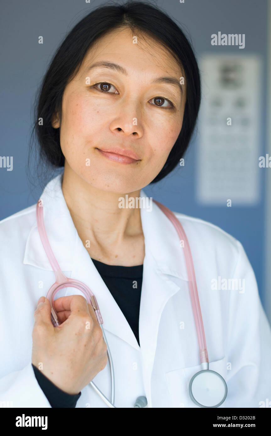Japanese doctor standing in office Stock Photo - Alamy