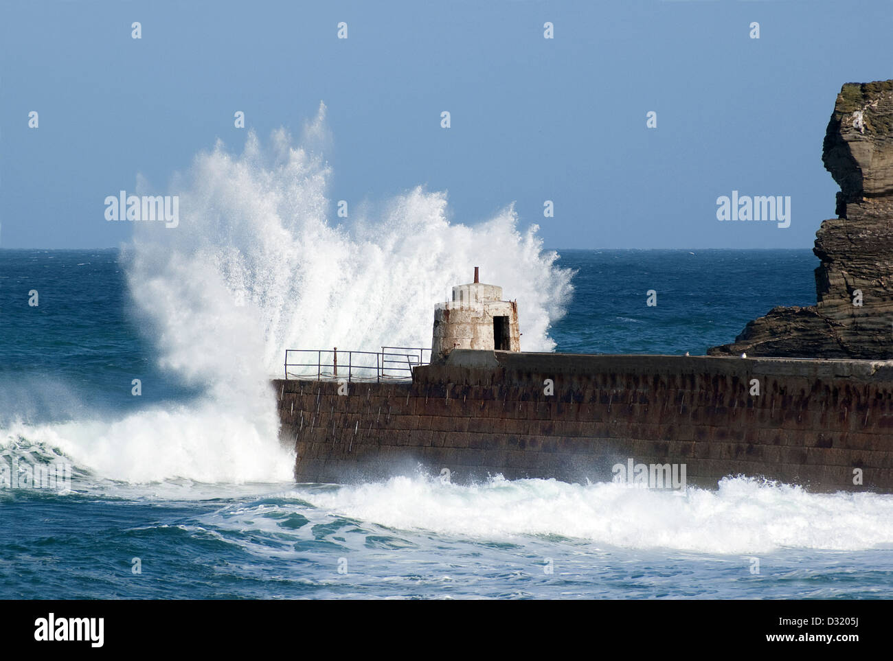 A stormy sea hits the harbour wall at Portreath in Cornwall, UK Stock ...