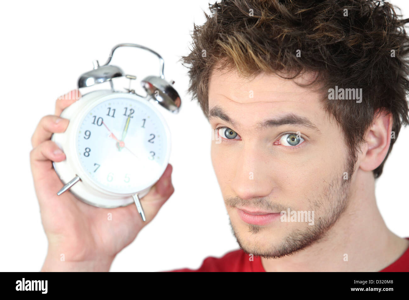 Young man with an alarm clock Stock Photo - Alamy