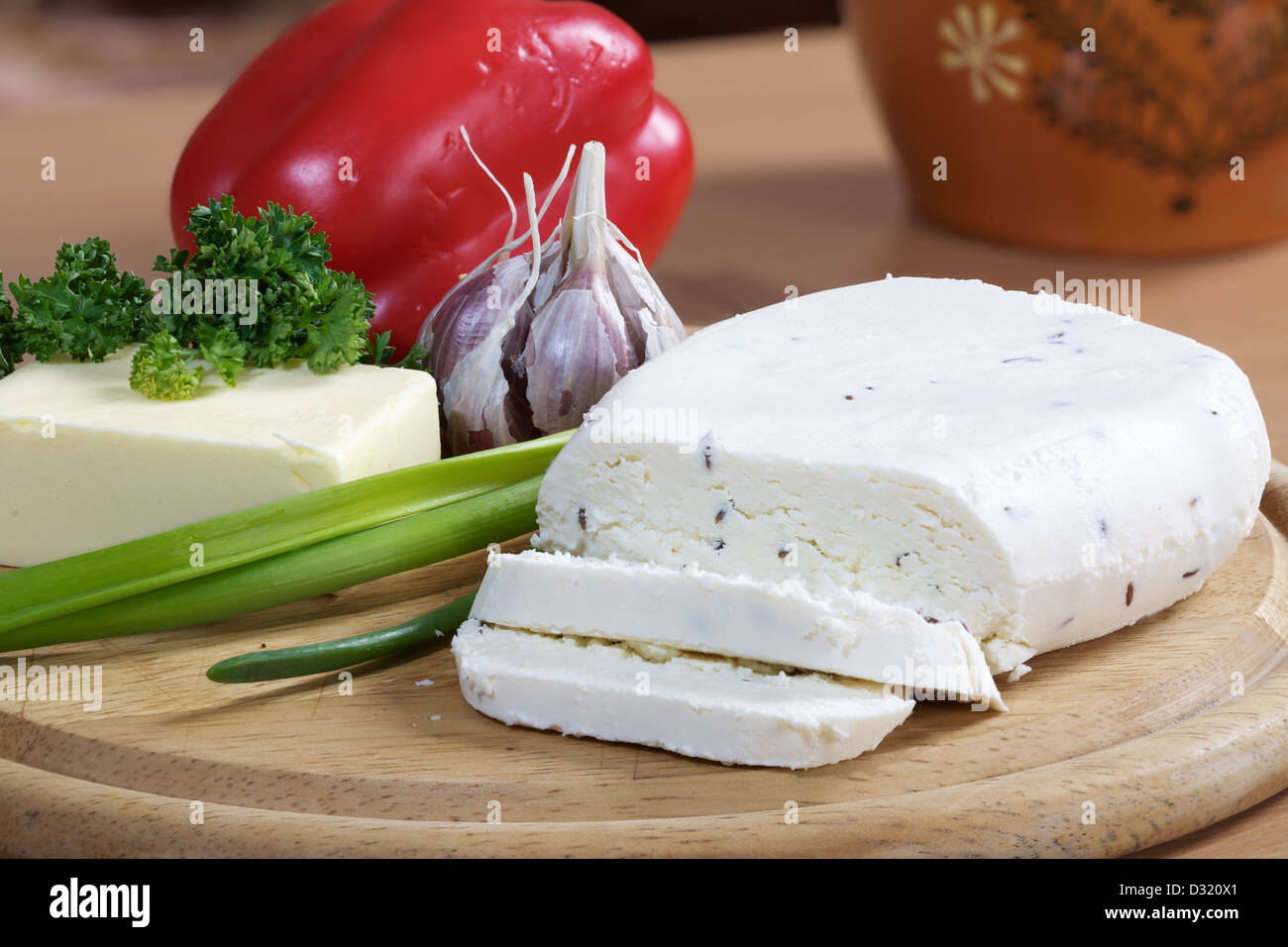 Cheese and butter with some veggies Stock Photo - Alamy