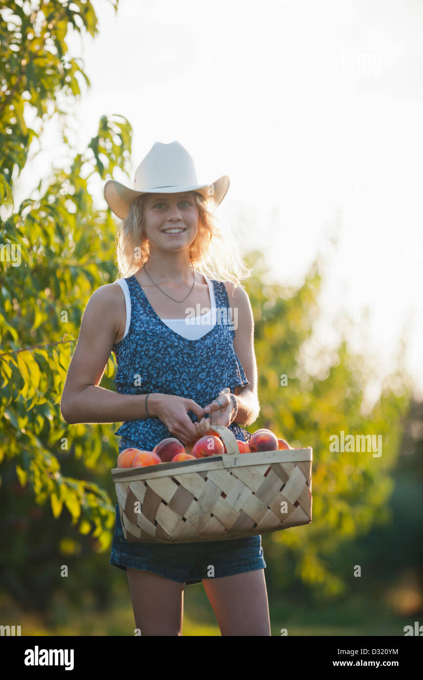 Caucasian woman picking fruit in orchard Stock Photo - Alamy