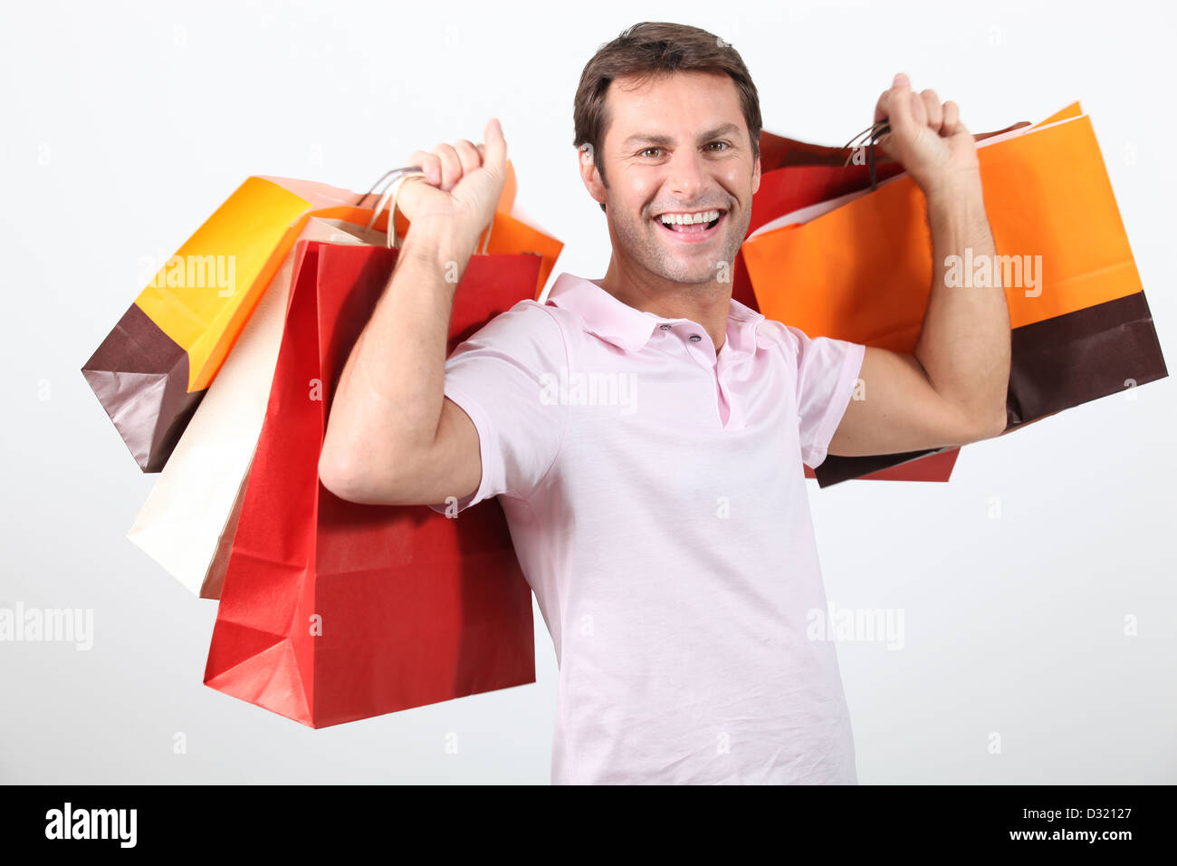 happy man holding shopping bags Stock Photo - Alamy