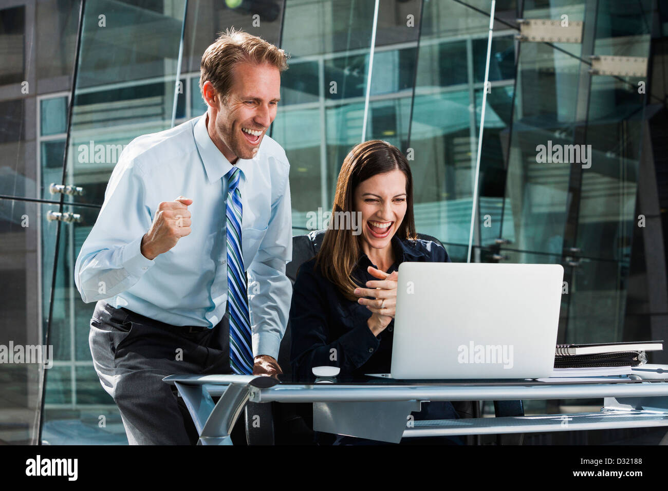 Caucasian business people cheering at laptop Stock Photo - Alamy