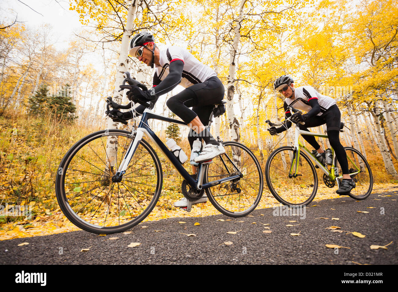Caucasian cyclists on rural road Stock Photo - Alamy