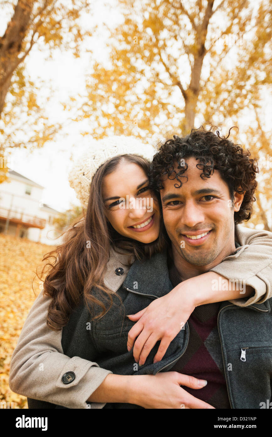 Couple hugging in autumn leaves Stock Photo - Alamy