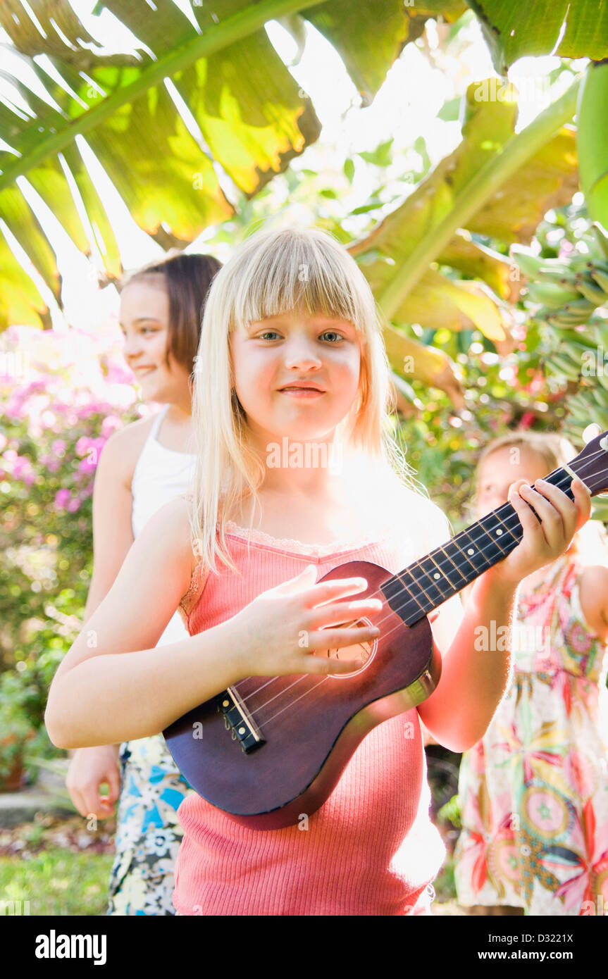 Caucasian girl playing ukulele outdoors Stock Photo - Alamy