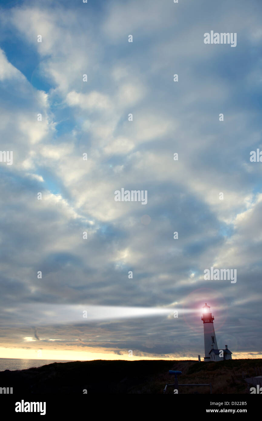 Lighthouse beaming under cloudy sky Stock Photo - Alamy