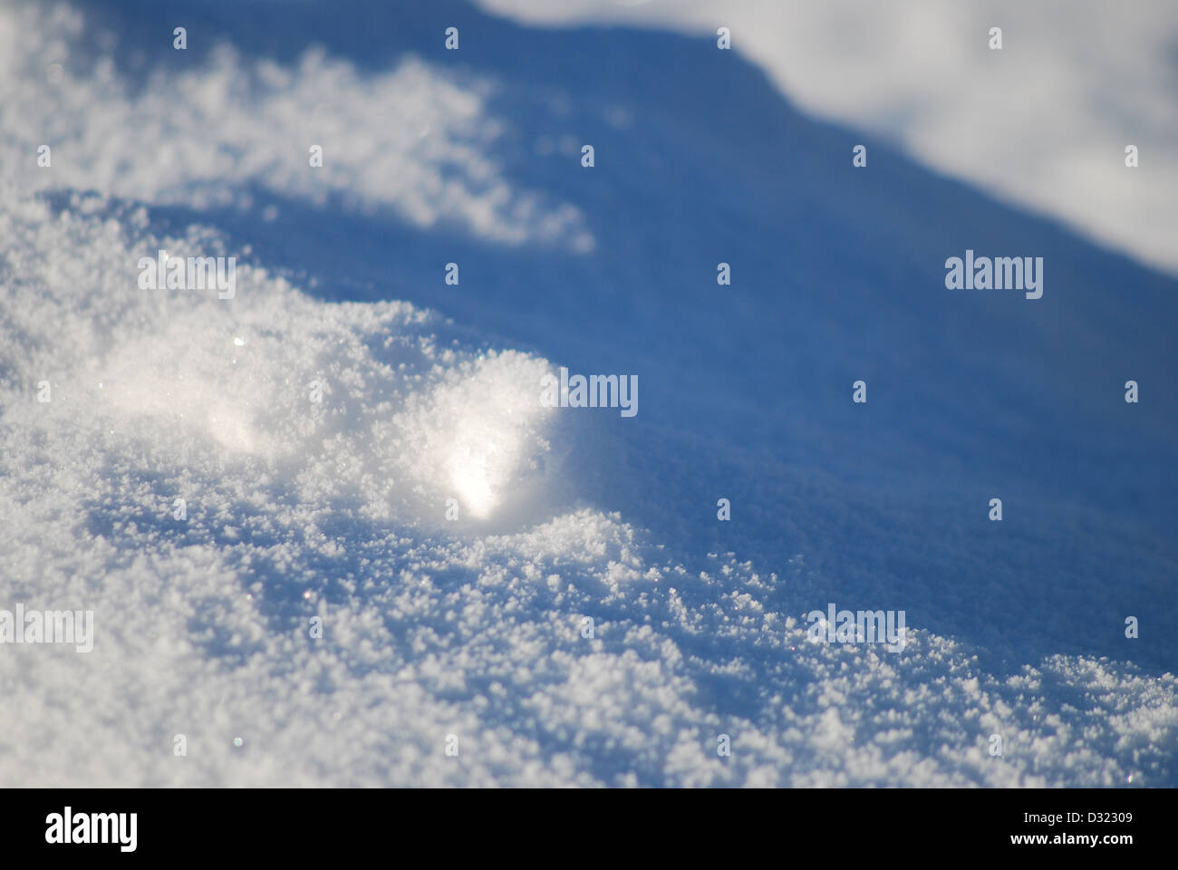 Up close detail of thick snow partly unspoiled untouched showing ...