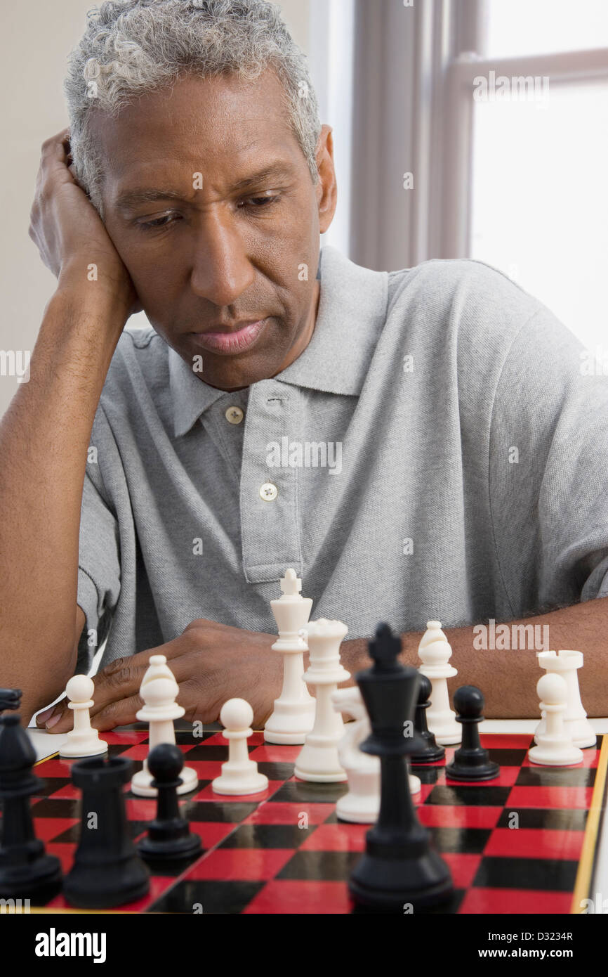 Mixed race man playing chess Stock Photo - Alamy