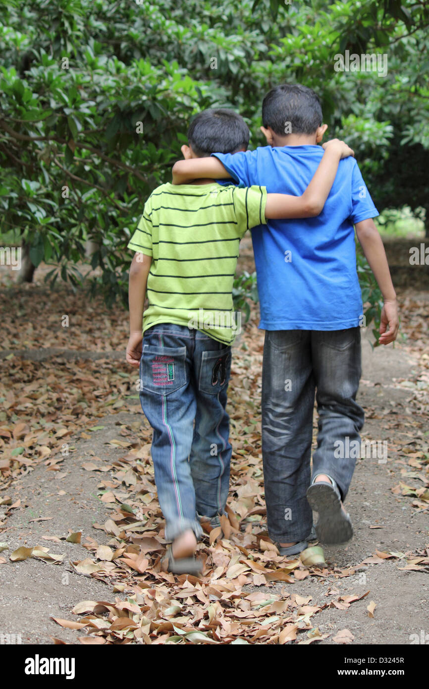 Two young friends walk in the park Stock Photo - Alamy