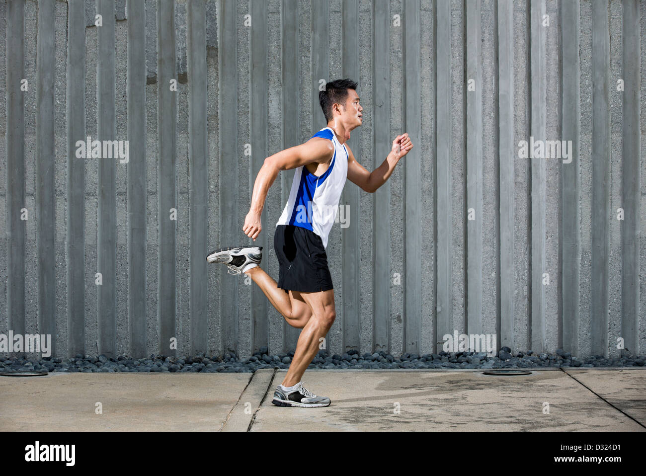Athlete Chinese man running in urban city. Asian Runner jogging ...