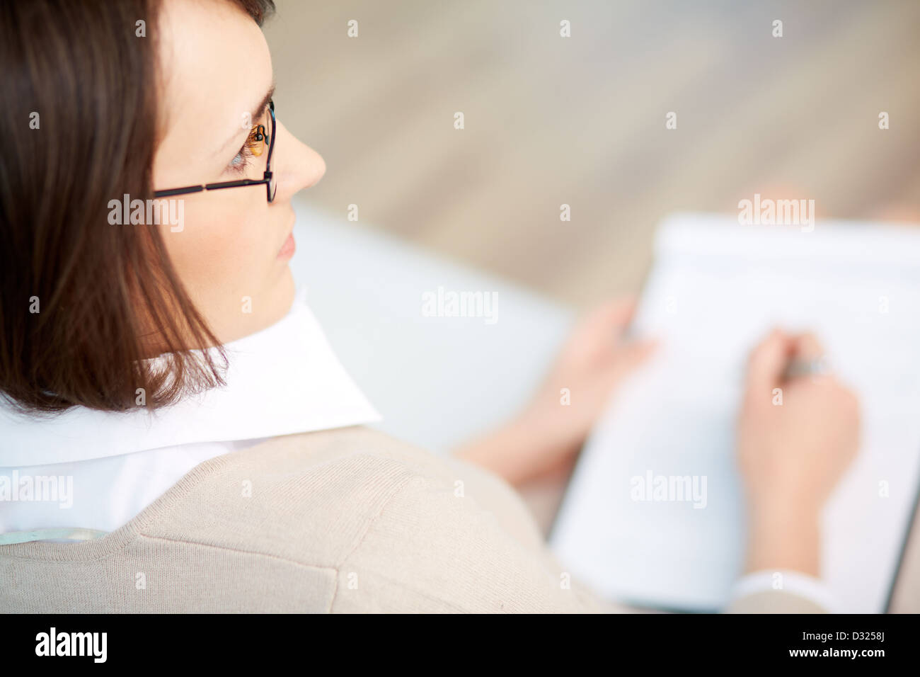 Professional psychiatrist keeping record during therapy session Stock ...