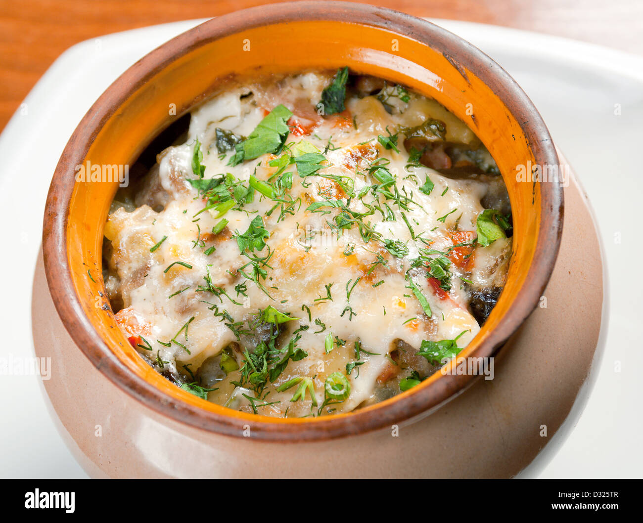 Roasted slices of potato in rustic clay pot Stock Photo - Alamy